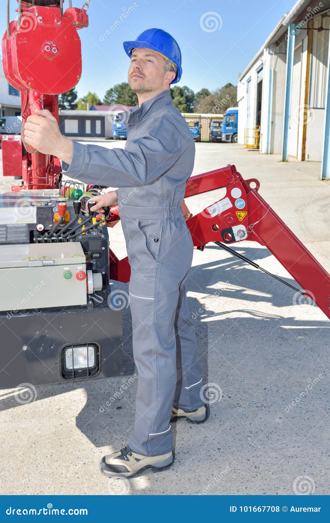 Worker Operating Crane at Construction Site Stock Photo - Image of ...