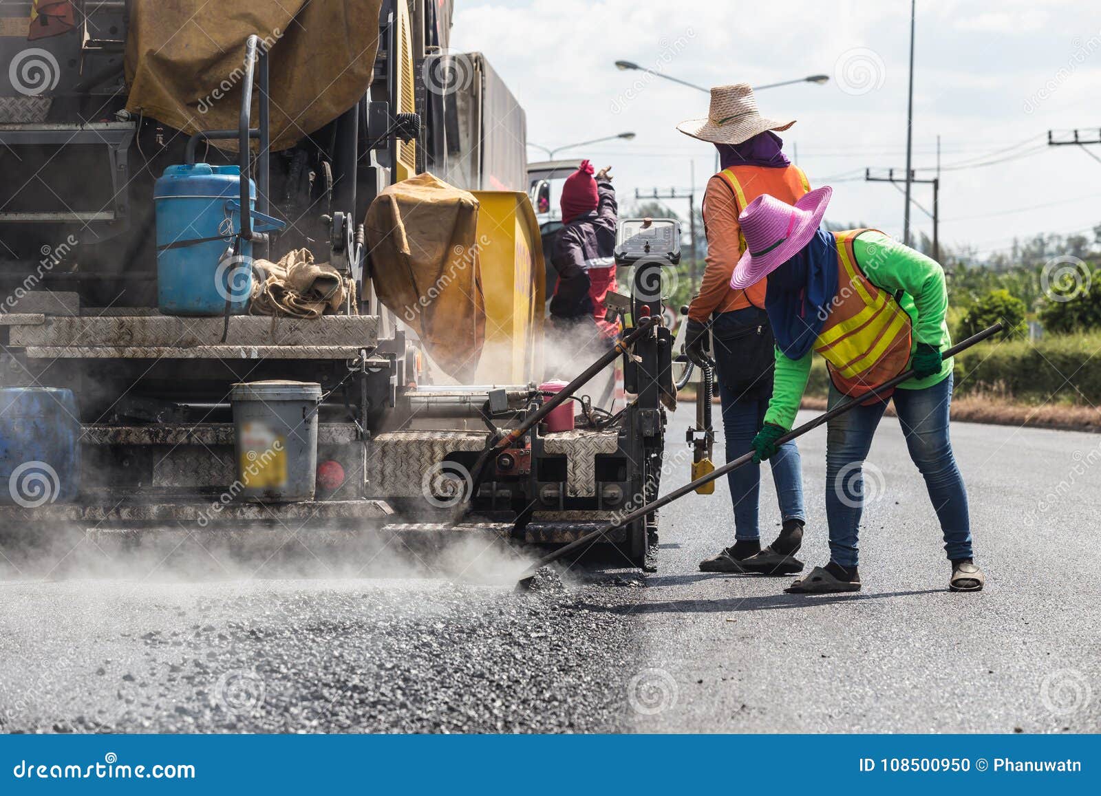 Worker Operating the Process of Building New Asphalt Road on the ...
