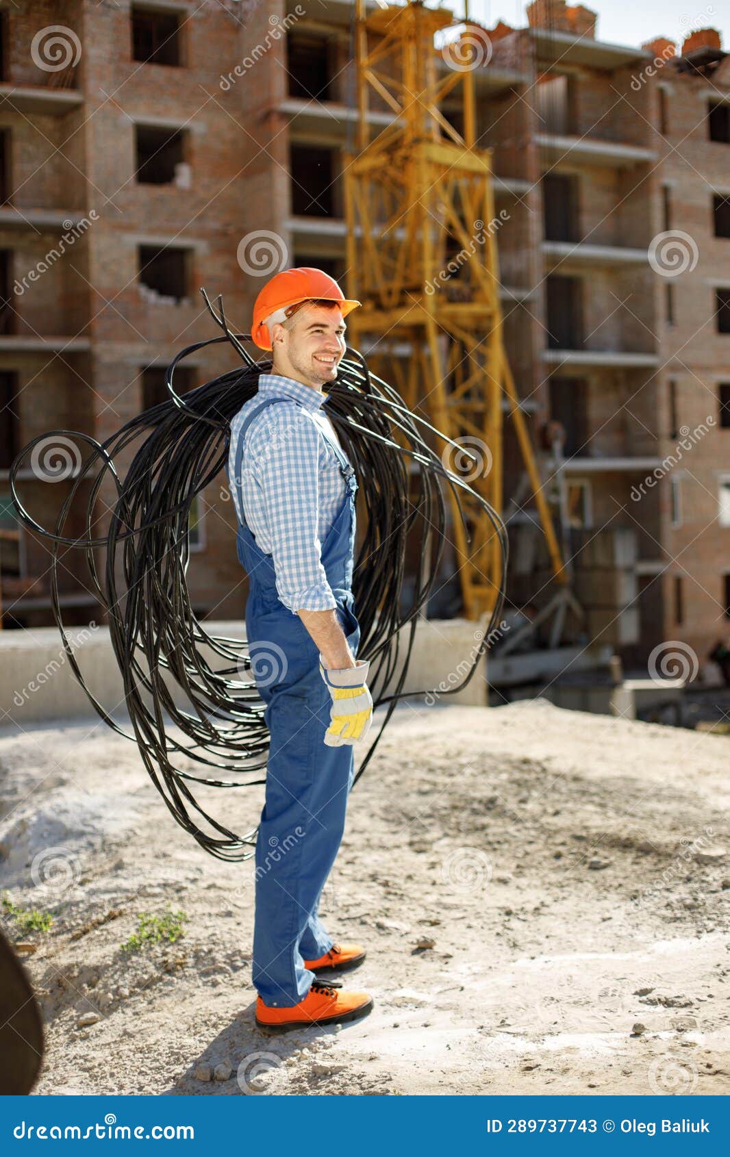 Worker in Orange Helmet at a Construction Site Holding a Wire Stock ...