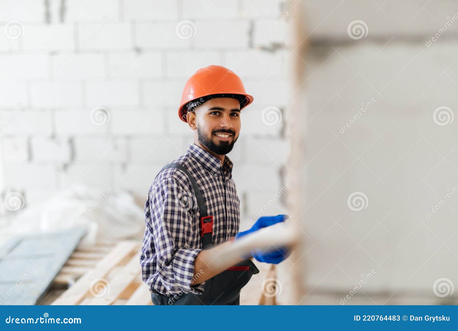 A Worker in Overall and Cap, Holding a Comb Putty-knife and Covering a ...