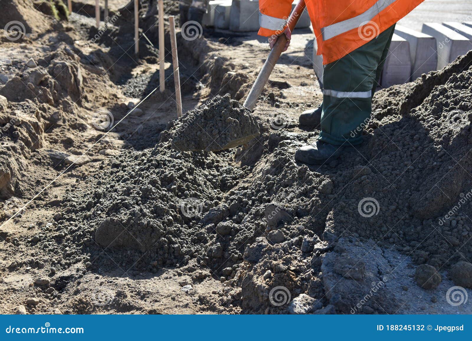 A Worker in Overalls Throws Cement into a Pit. Stock Photo - Image of ...