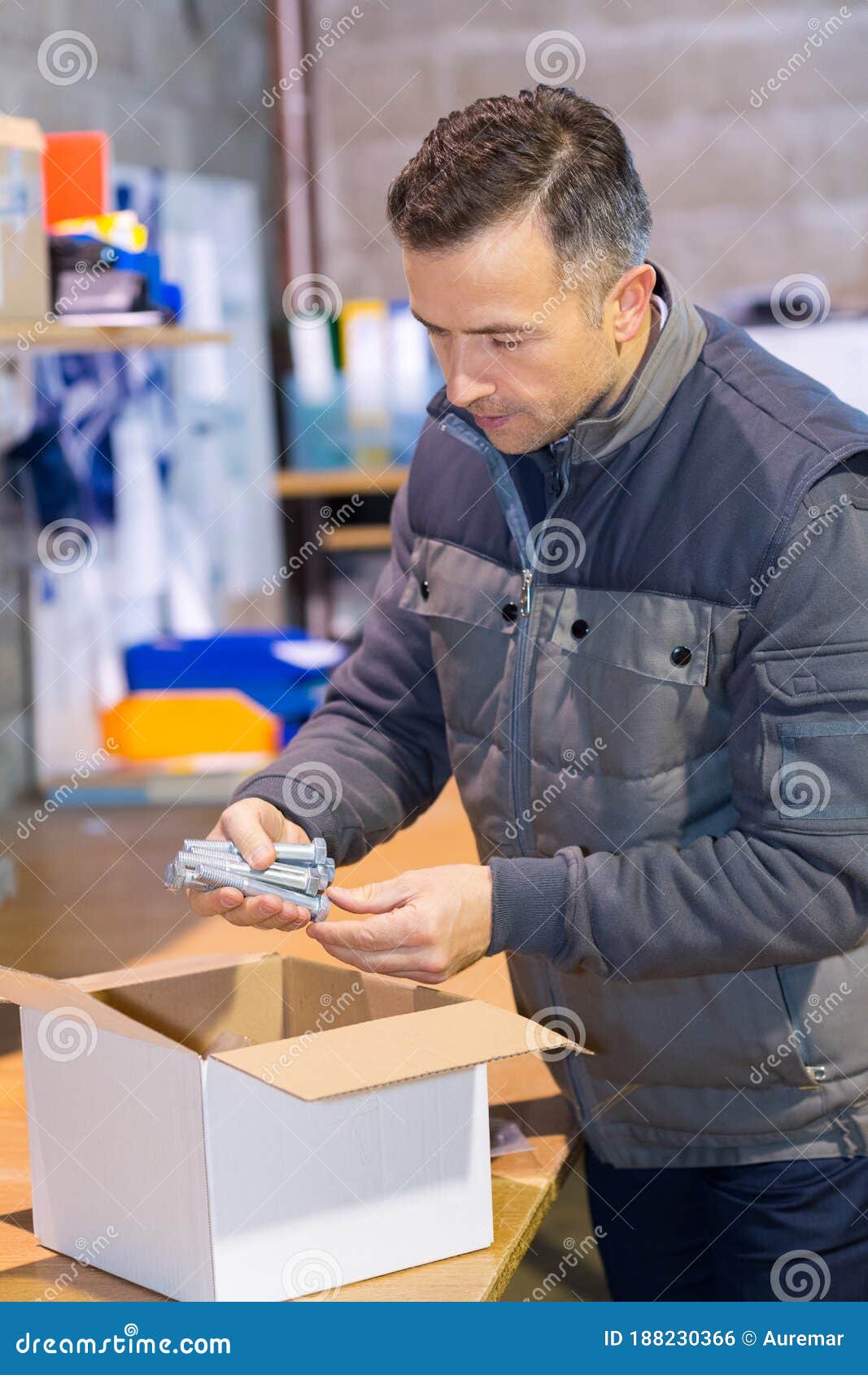 Worker Packaging Order For Metal Bolts Into Cardboard Box Royalty-Free ...
