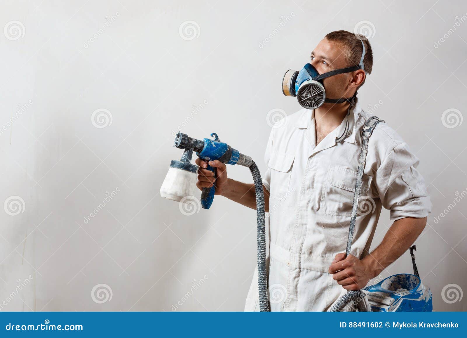 Worker Painting Wall with Spray Gun in White Color. Stock Photo - Image ...
