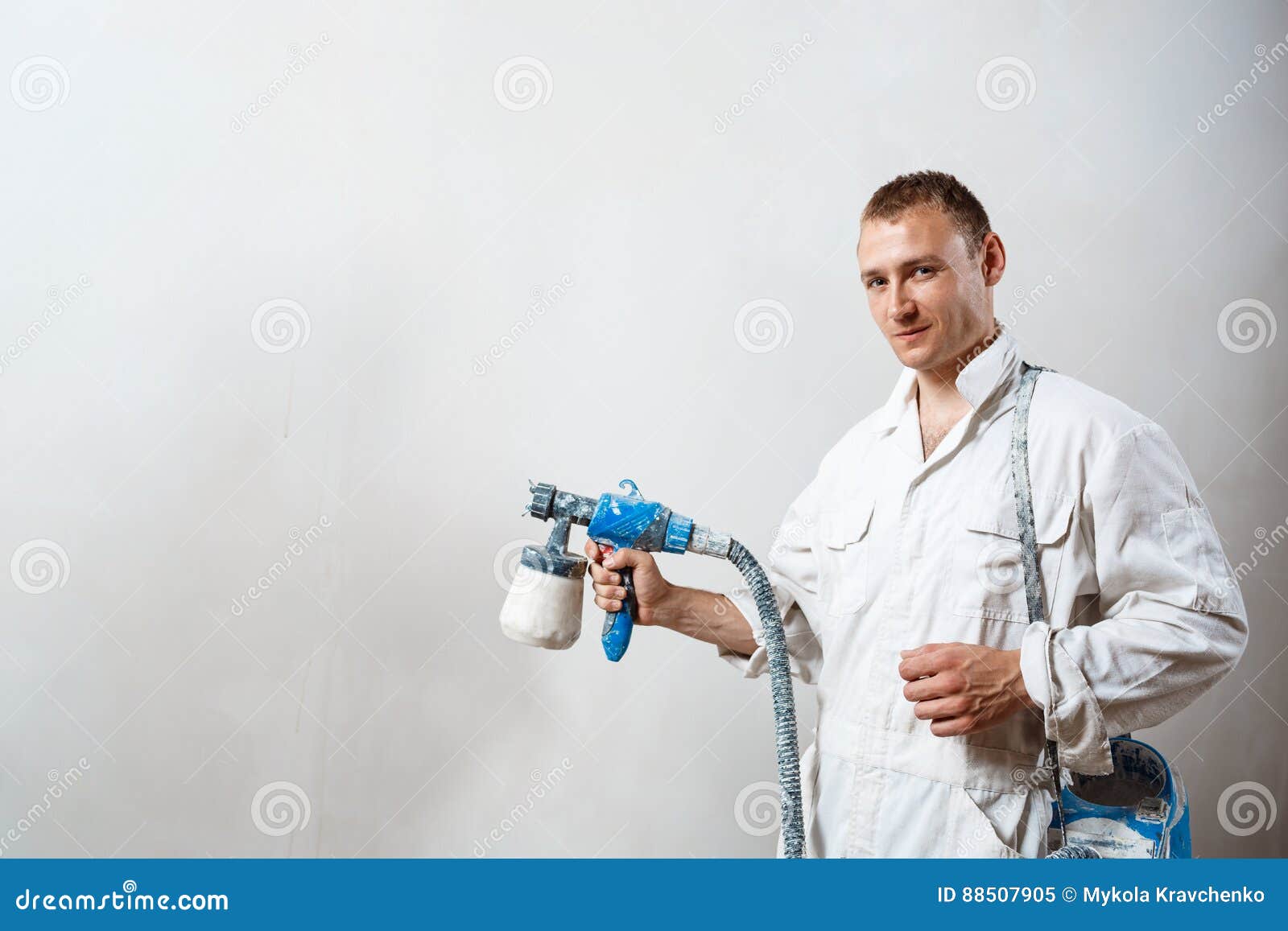 Worker Painting Wall with Spray Gun in White Color. Stock Image - Image ...