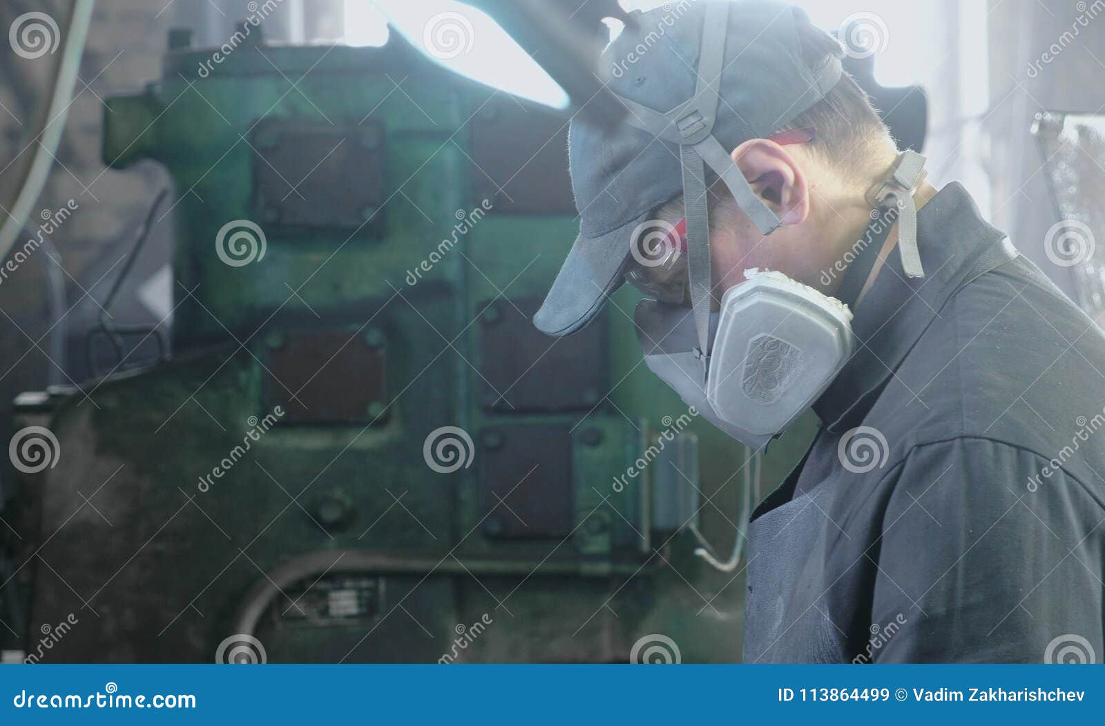 Worker Performs His Job in a Protective Mask on His Face in the Shop ...