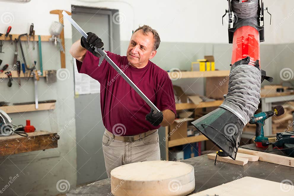Worker Performs Measurements on Wooden Workpiece with Caliper. Working ...
