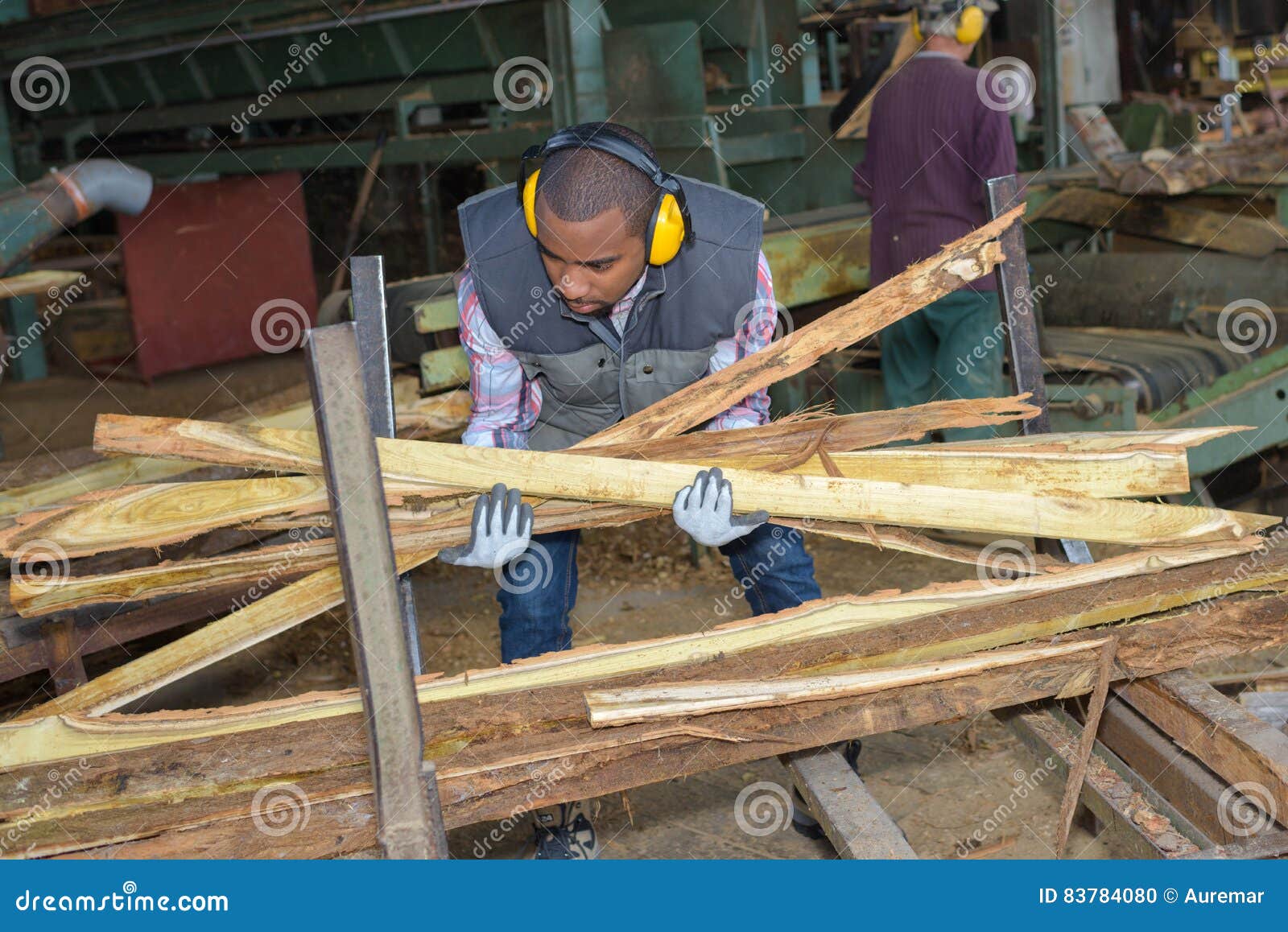 Worker picking up wood stock photo. Image of company - 83784080