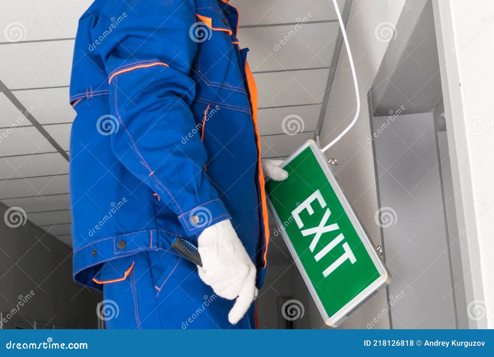 Worker Places an Emergency Exit Sign Stock Photo - Image of fastening ...