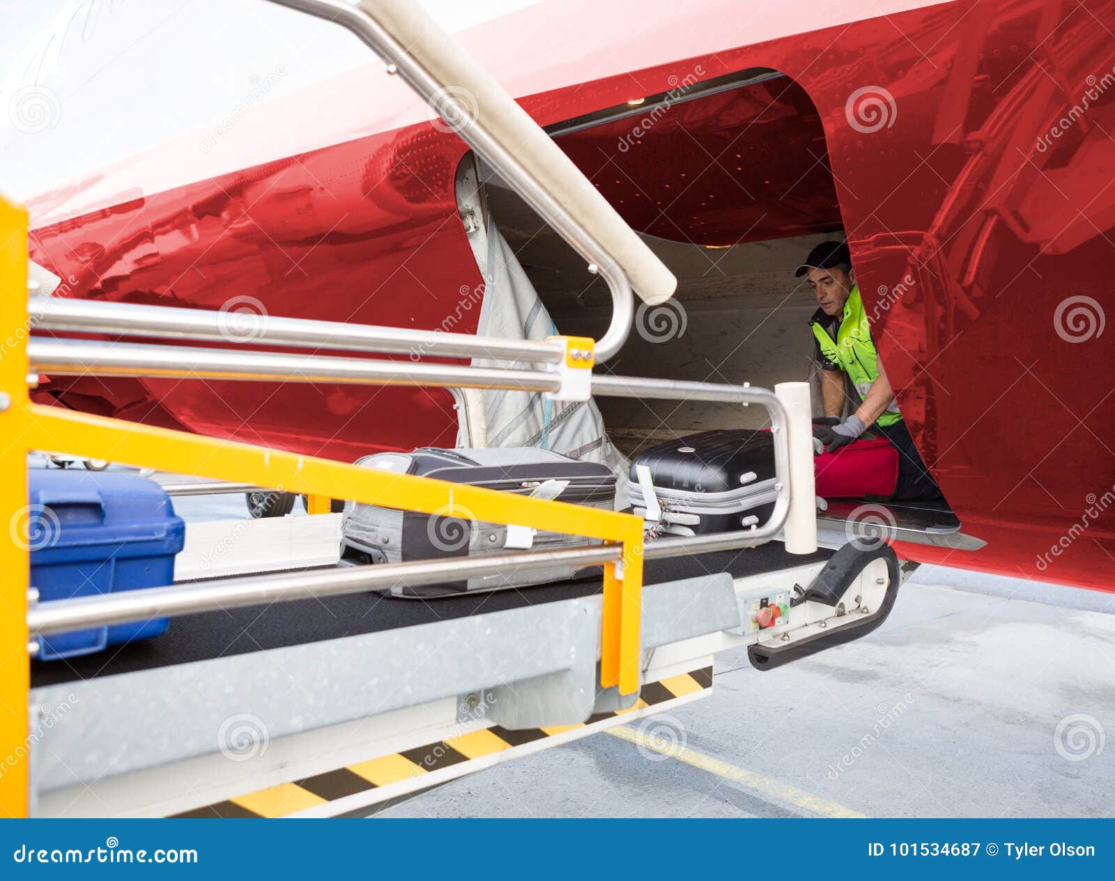 Worker Placing Baggage on Conveyor while Unloading Airplane Stock Image ...