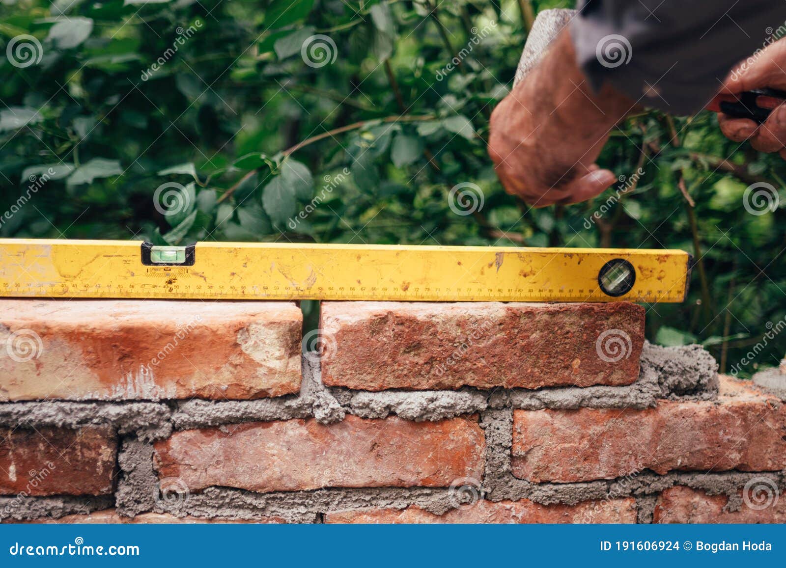 Worker Placing and Installing Bricks on Exterior Wall on House ...