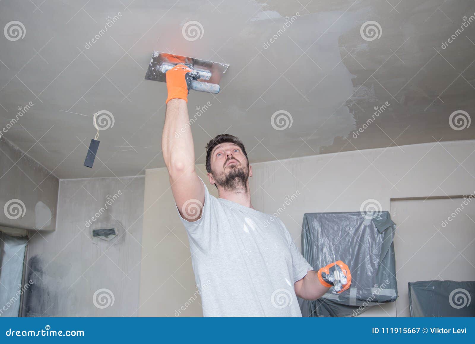 Worker plastering ceiling stock image. Image of worker - 111915667