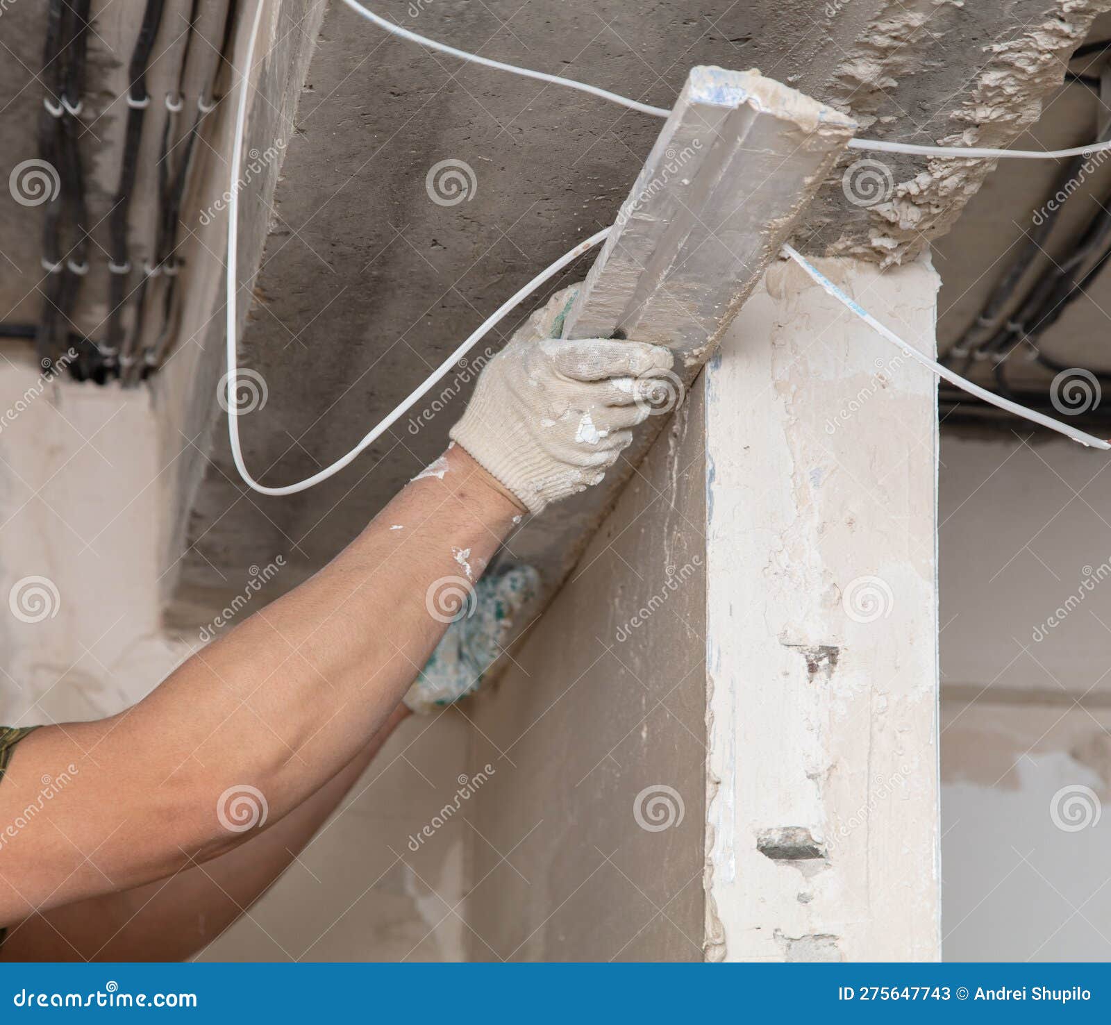 A Worker is Plastering the Walls of a House Under Construction Stock ...