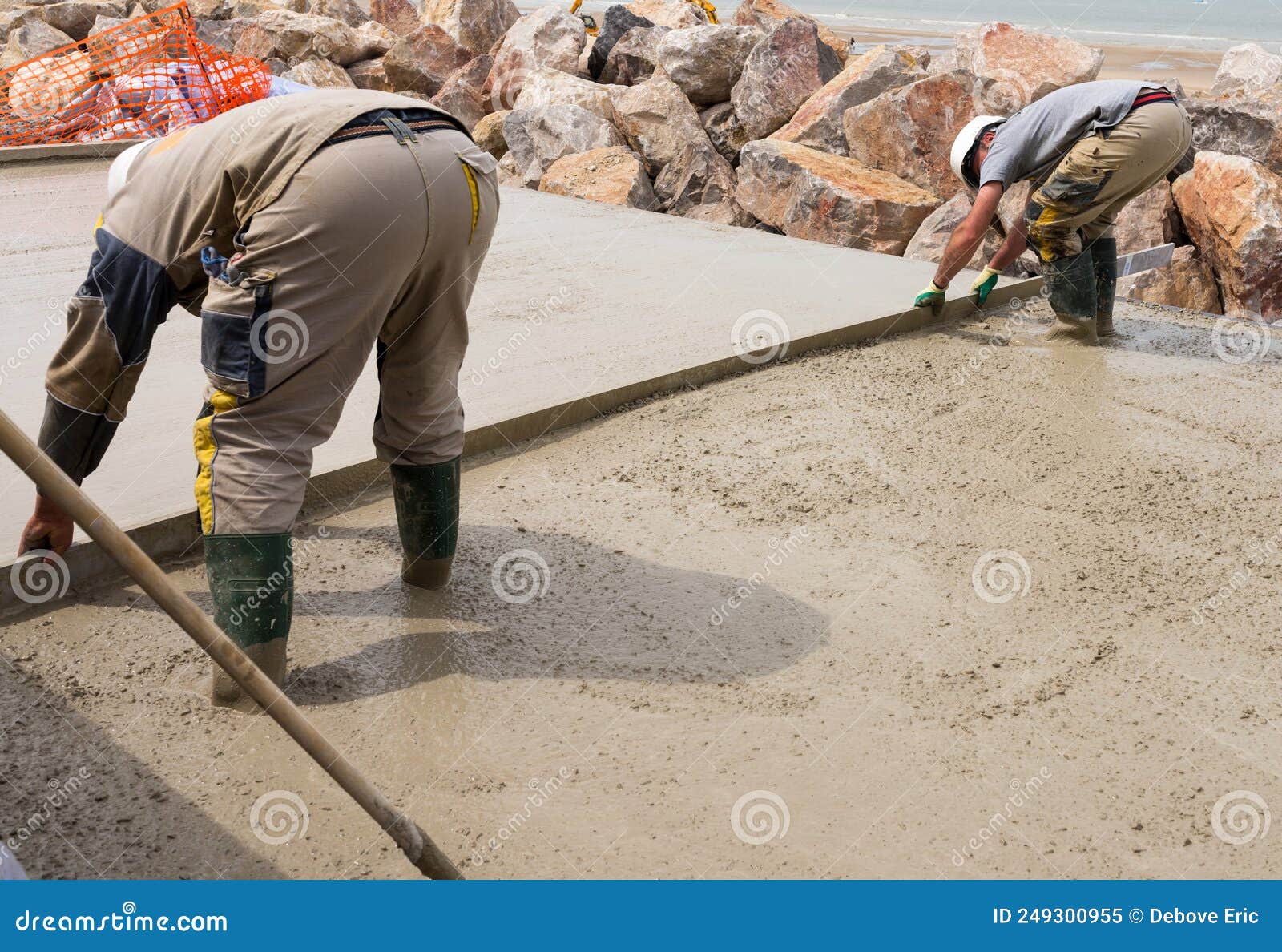 Construction of a Concrete Screed with Workers Leveling the Road or the ...