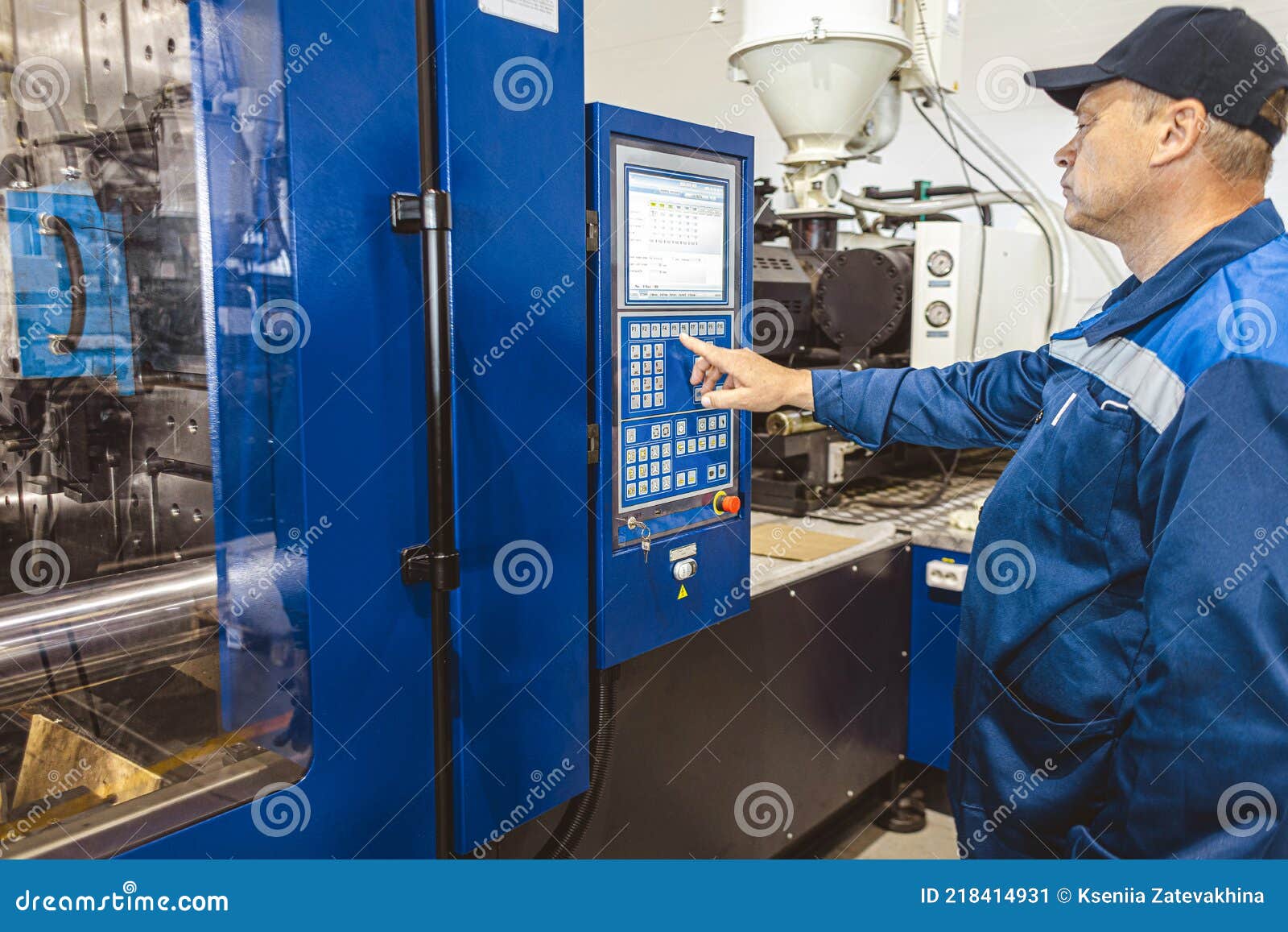A Worker Presses a Button and Starts an Automatic Manufacturing Process ...