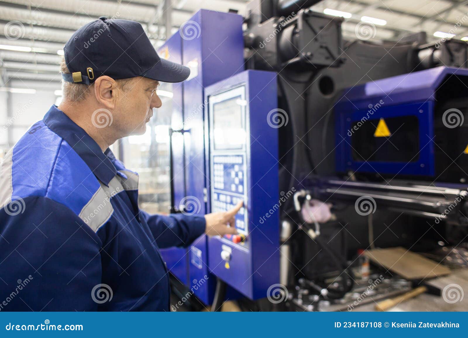 A Worker Presses a Button and Starts an Automatic Manufacturing Process ...
