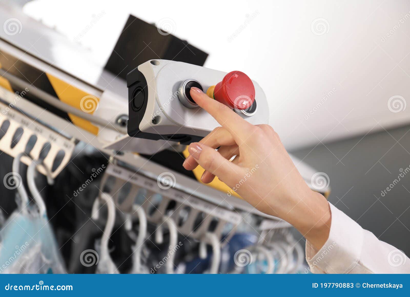 Worker Pressing Button on Control Panel of Garment Conveyor at Modern ...