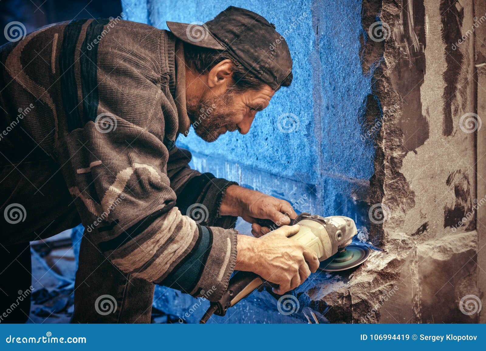 The Worker Processes the Granite Stone with a Grinder. Stock Image ...