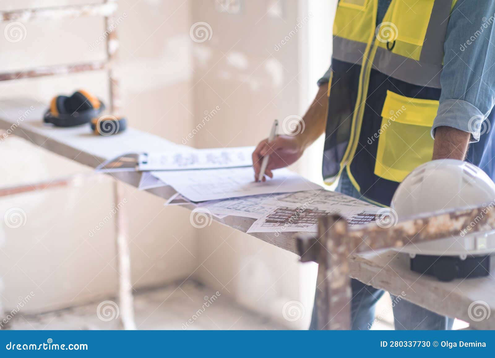 Worker in Professional Uniform Editing and Correcting Construction ...