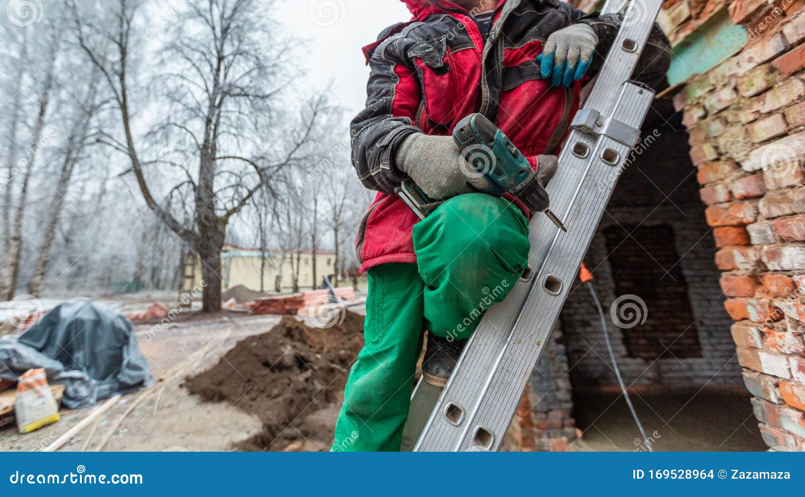 Worker in Protect Gloves is Holding the Hand Screwdriver on the Ladder ...