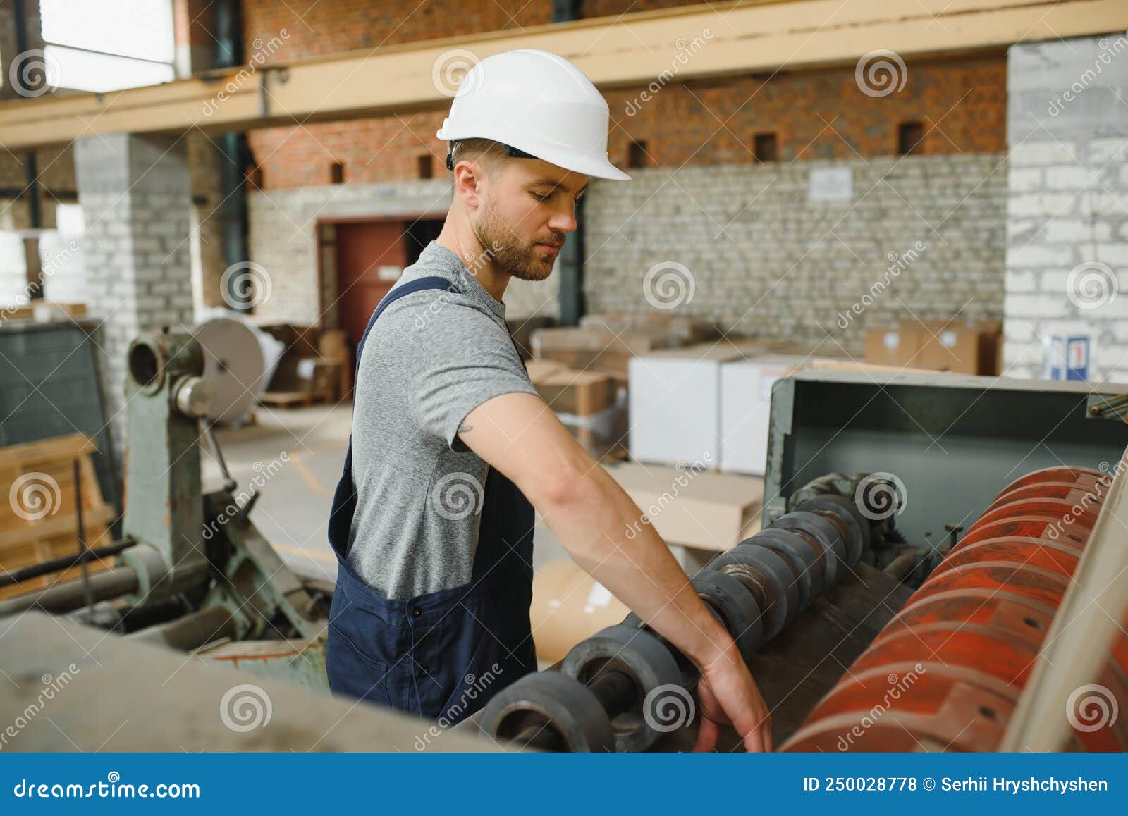 Worker in Protective Clothing in Factory Using Machine Stock Photo ...