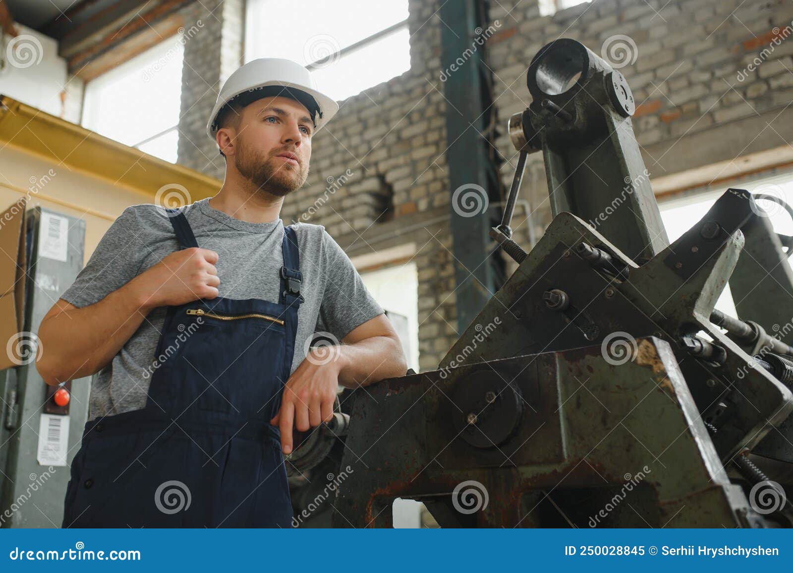Worker in Protective Clothing in Factory Using Machine Stock Image ...