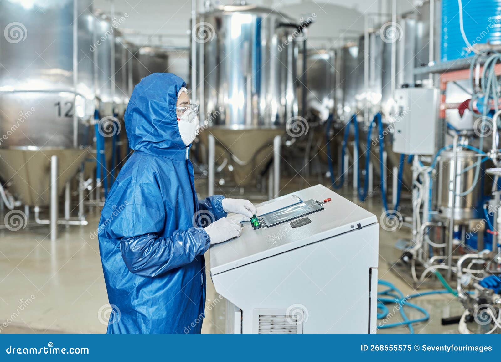 Worker in Protective Gear Operating Equipment at Factory Stock Image ...