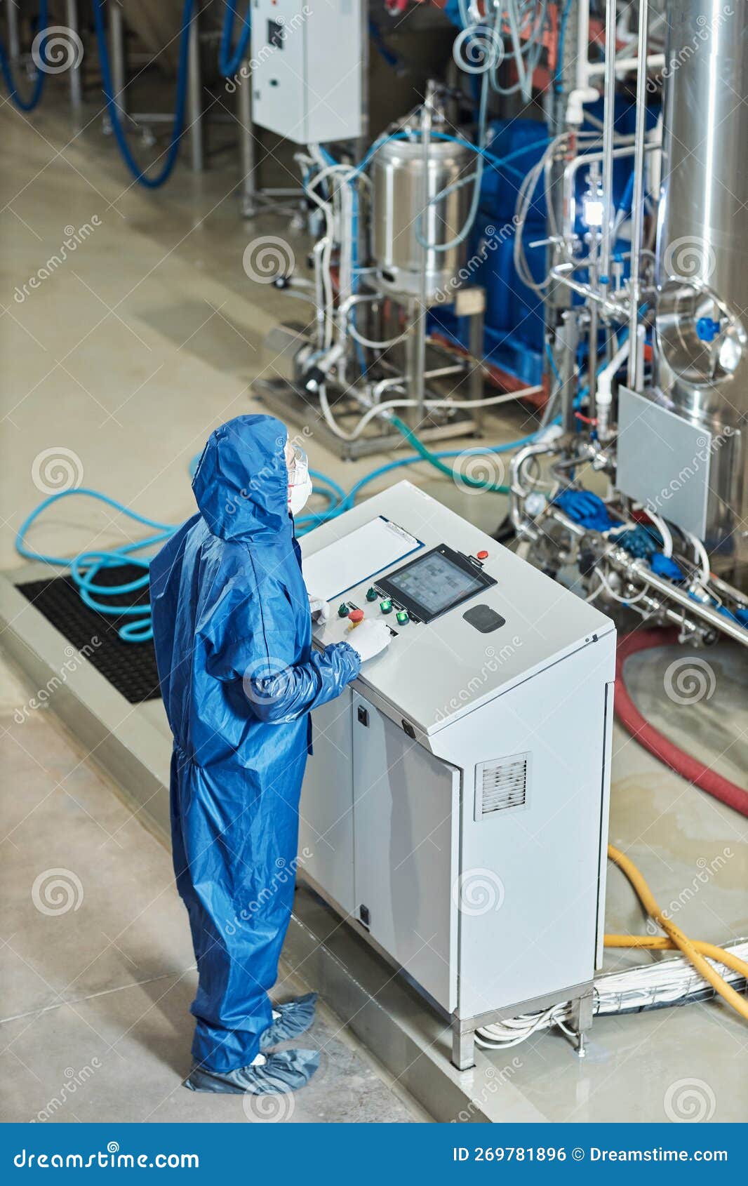 Worker in Protective Gear Operating Equipment at Factory Stock Photo ...