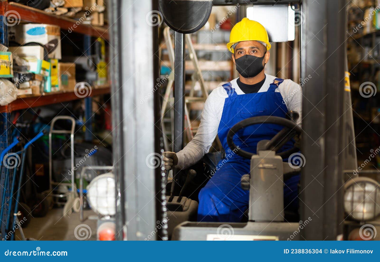 Worker in Protective Mask Driving Forklift in Building Materials Store ...