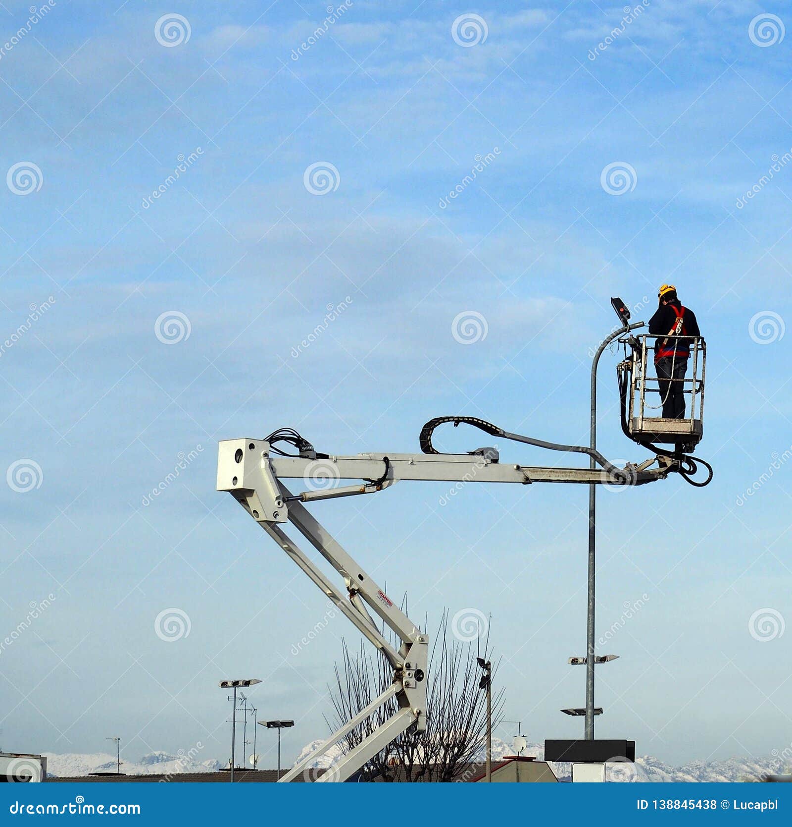 Worker with Protective Suits on Aerial Platform of Cherry Pickers Does ...