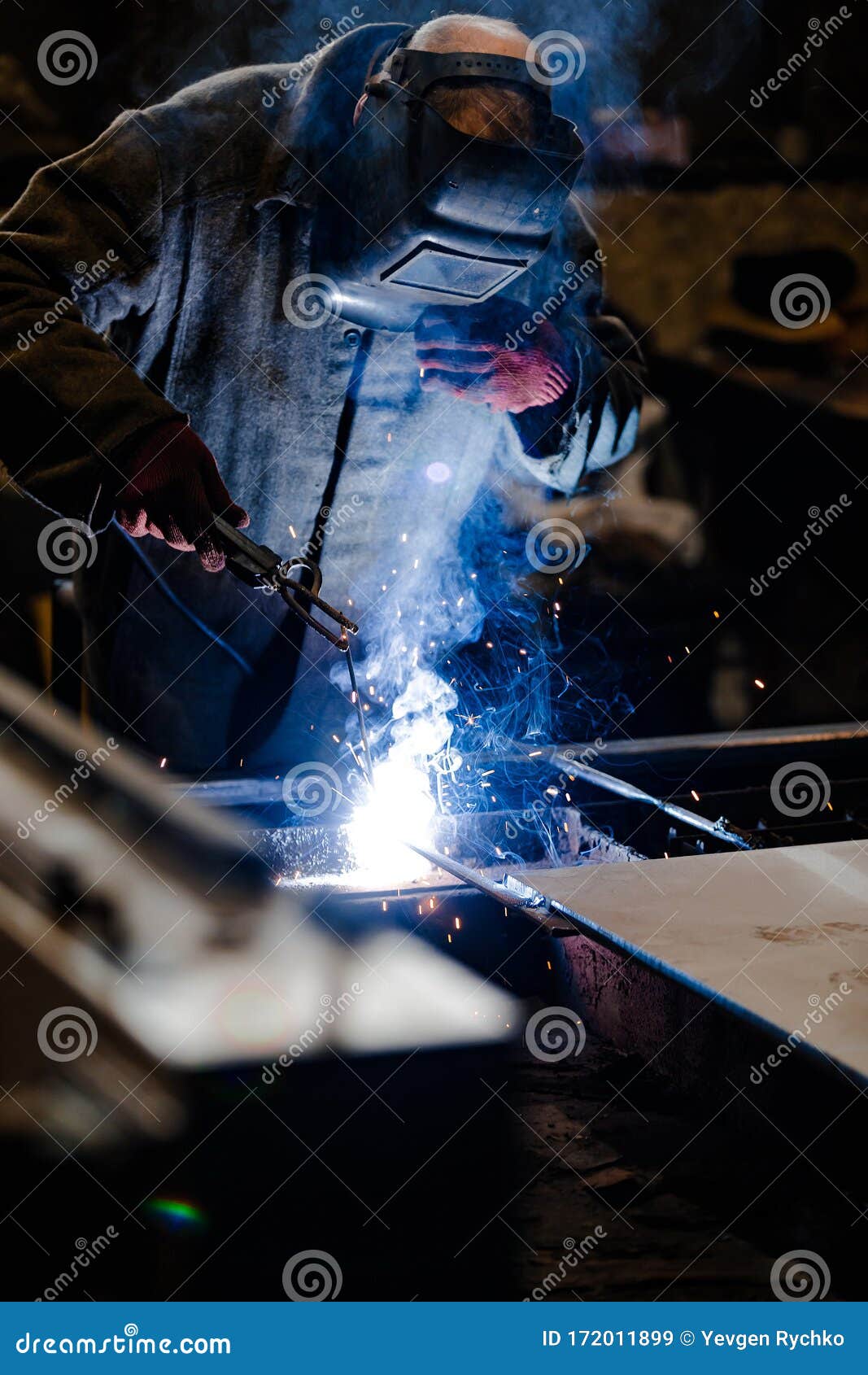 Worker in Protective Uniform and Mask Welding Metal. Stock Image ...