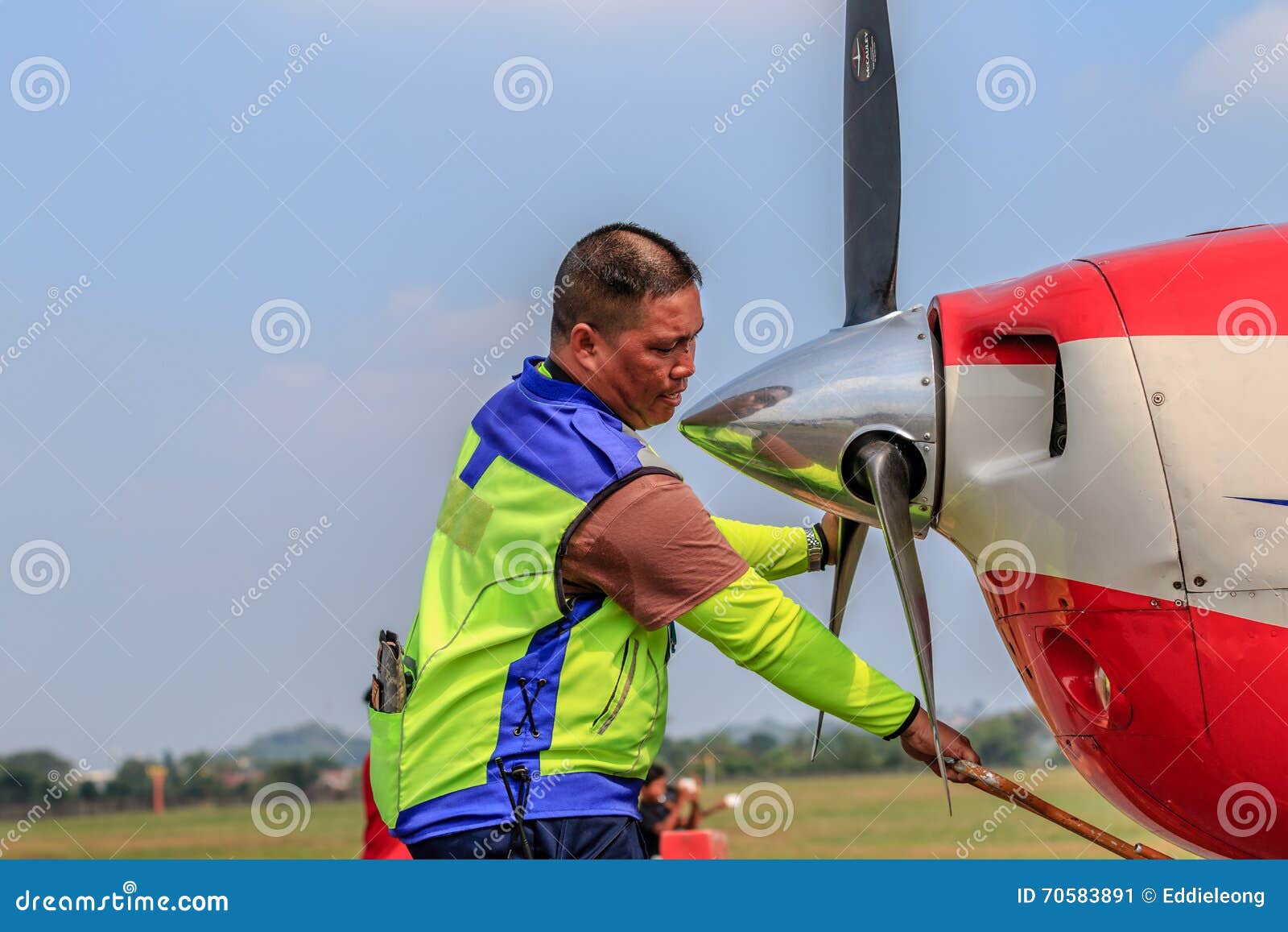 A Worker Pulling an Airplane Editorial Photo - Image of worker, plane ...
