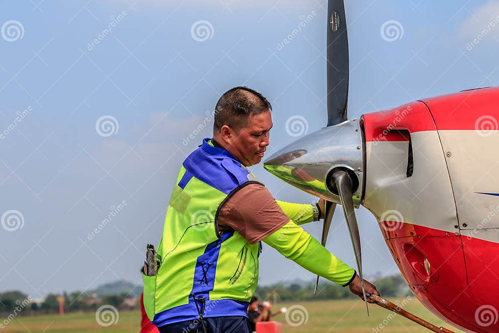 A Worker Pulling an Airplane Editorial Photo - Image of worker, plane ...