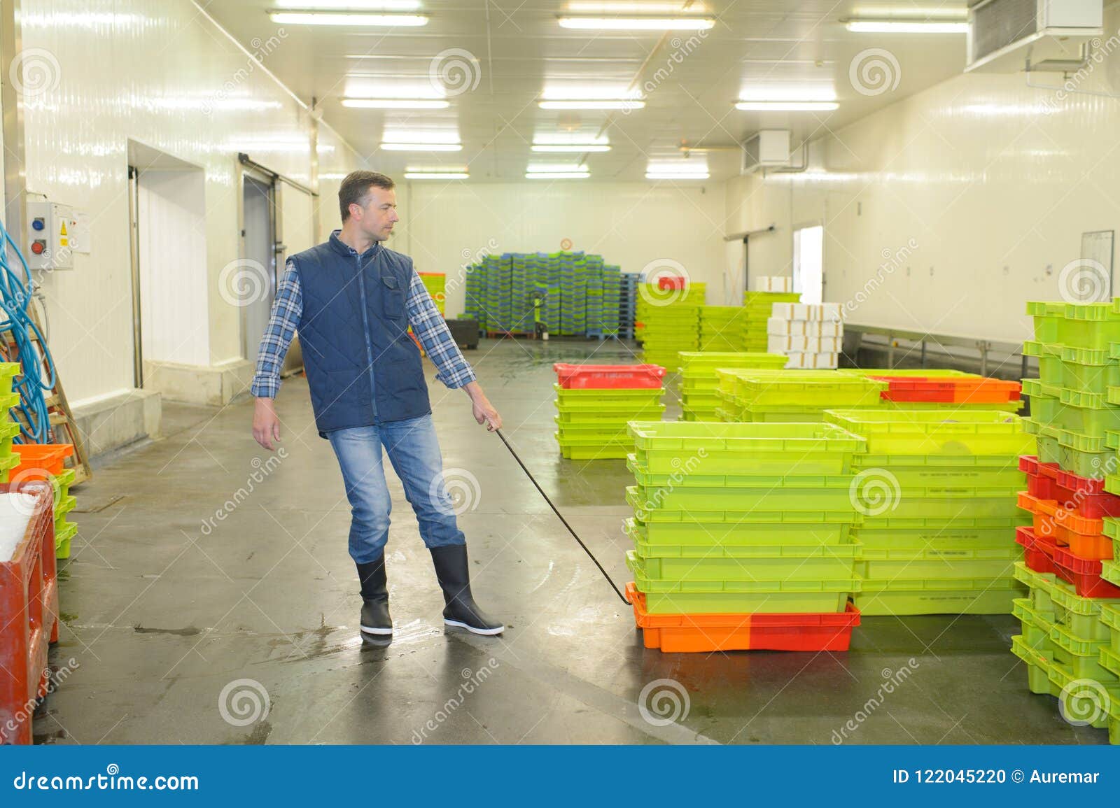 Worker Pulling Plastic Crates Stock Photo - Image of pull, movement ...