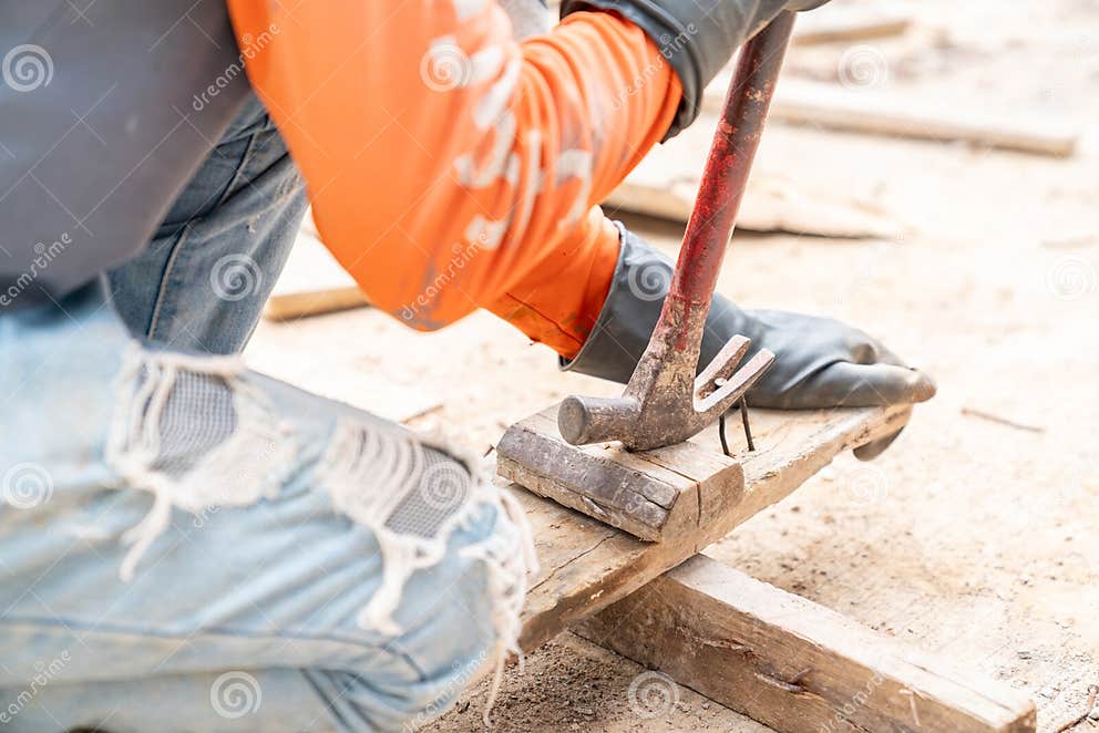 Worker Pulling Rusty Nail Out of Old Pinewood with Hammer Stock Photo ...