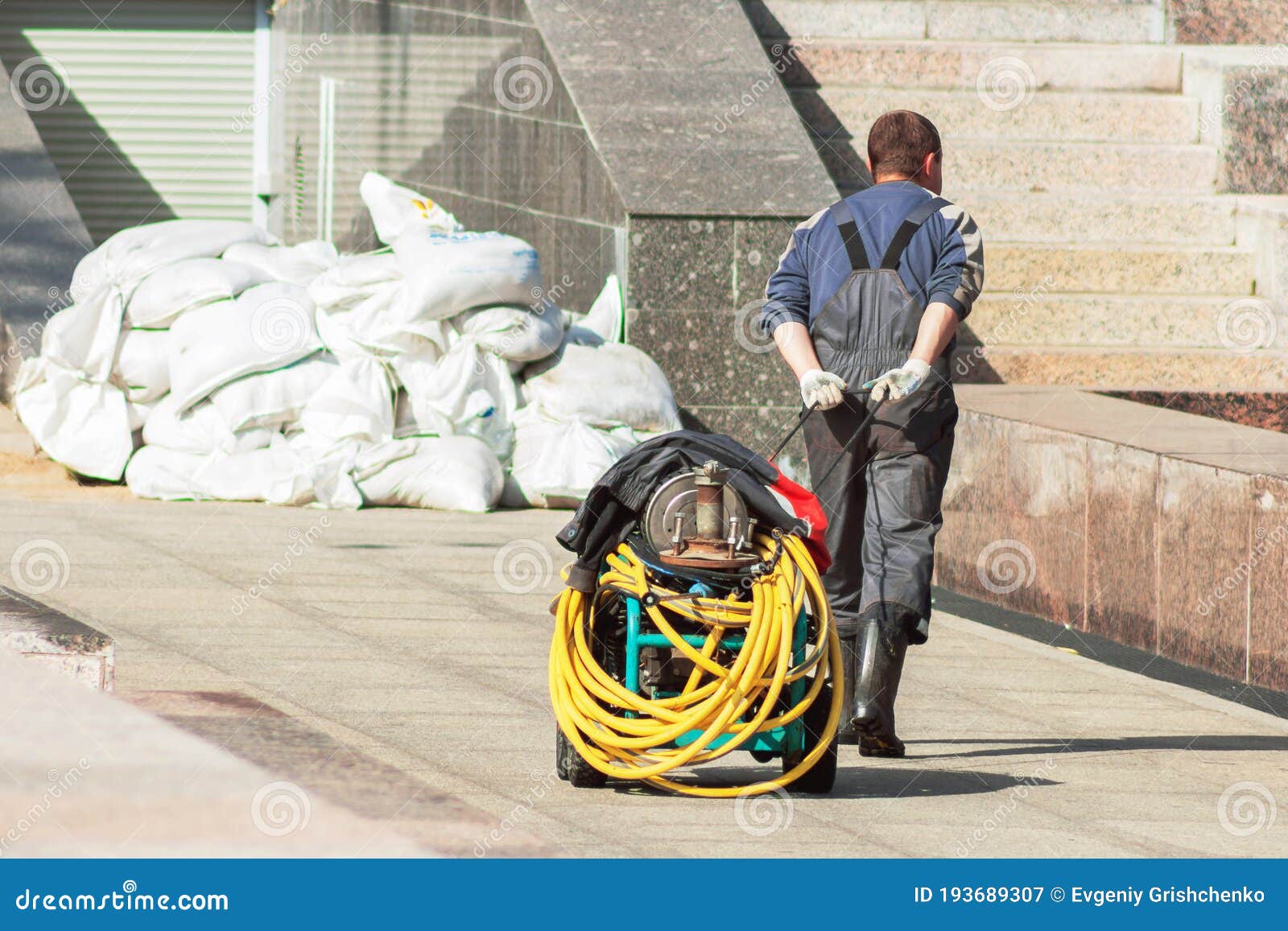 Worker Pulls a Hose Pumping Station Construction Technology Editorial ...