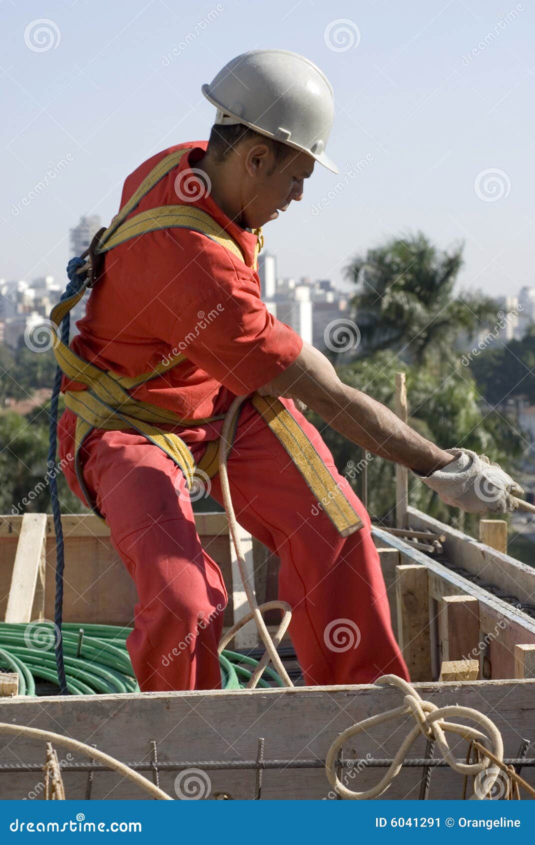 Worker Pulls Hose - Vertical Stock Image - Image of twenties, male: 6041291
