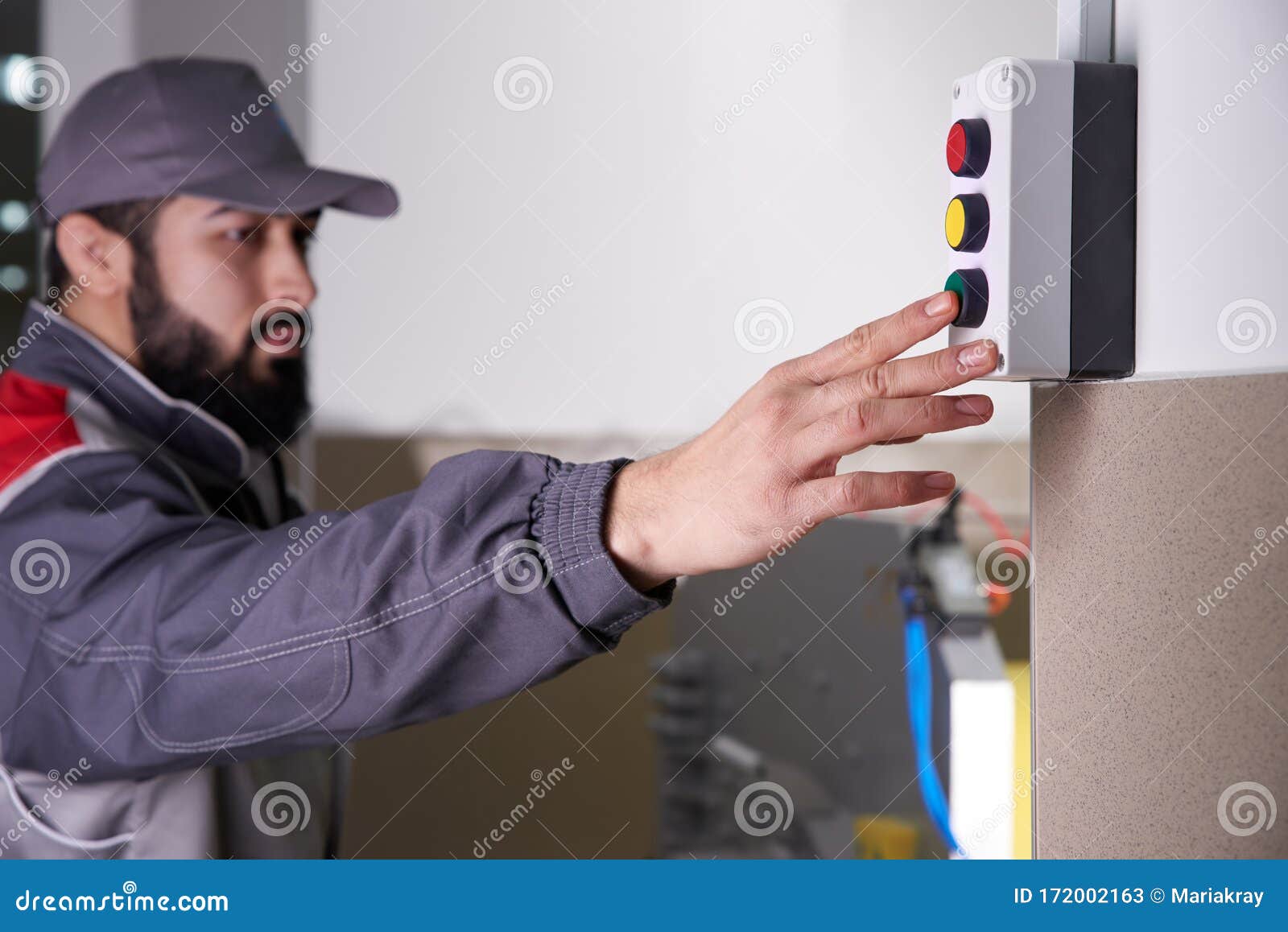 Worker Pushing Green Button Operating a Machine in a Factory, Close Up ...