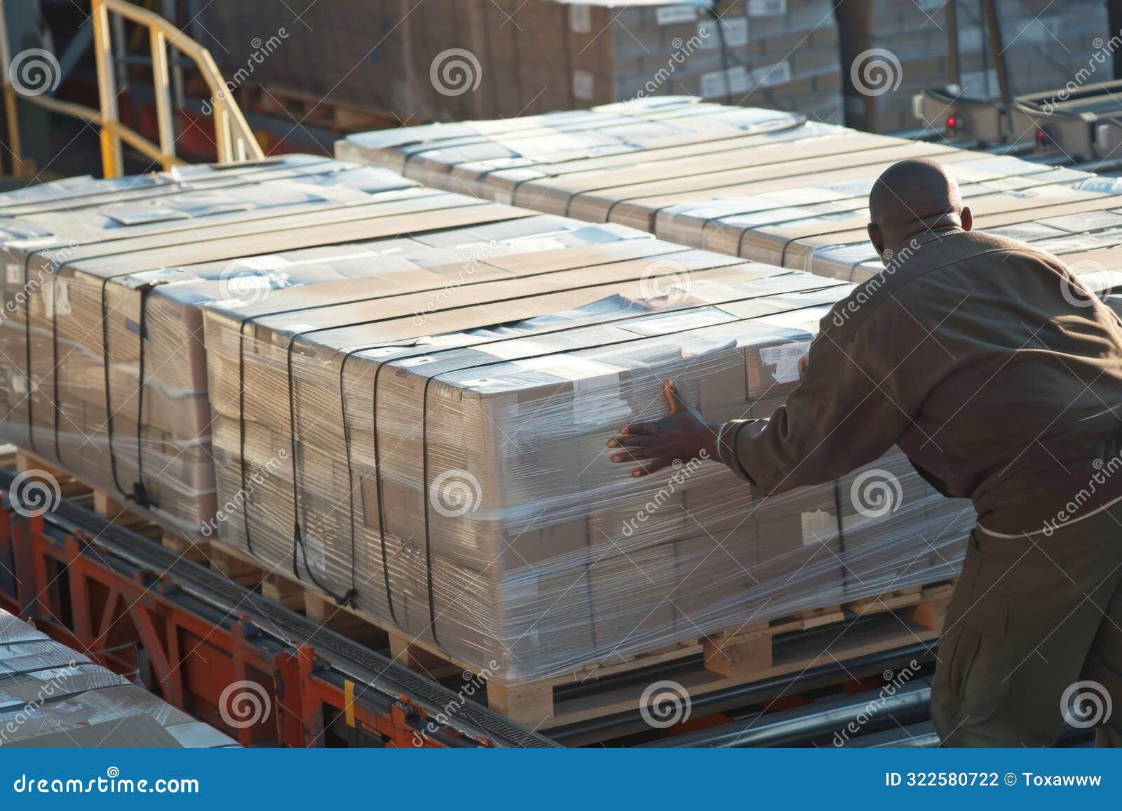 Worker Pushing a Pallet of Boxes in a Warehouse Stock Photo - Image of ...