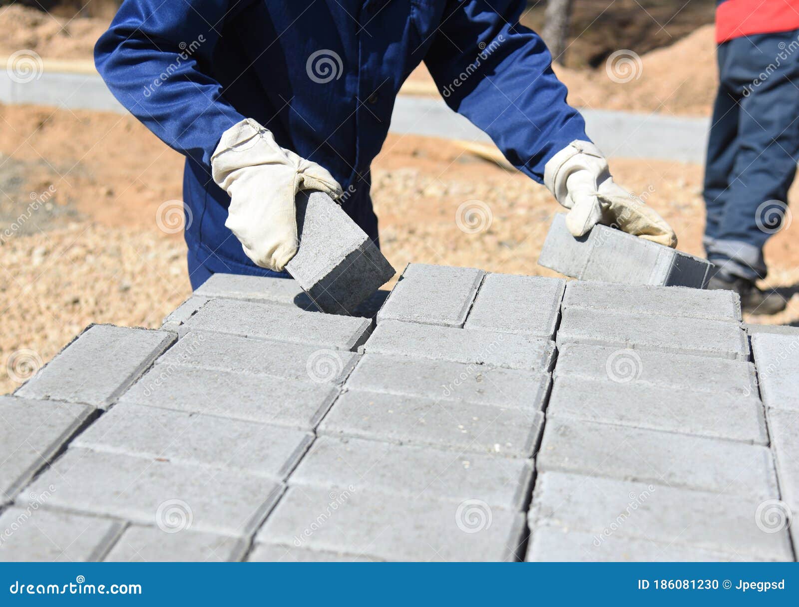 A Worker Puts Bricks on a Pallet. Stock Photo - Image of paving, repair ...