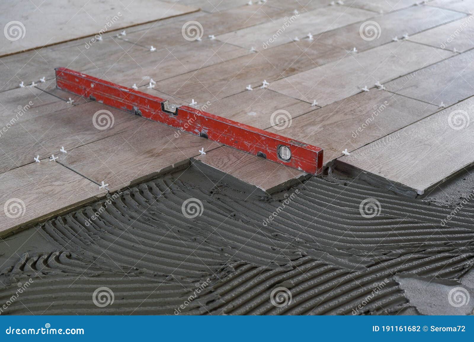 The Worker Puts Ceramic Tiles on the Construction Site Stock Photo ...