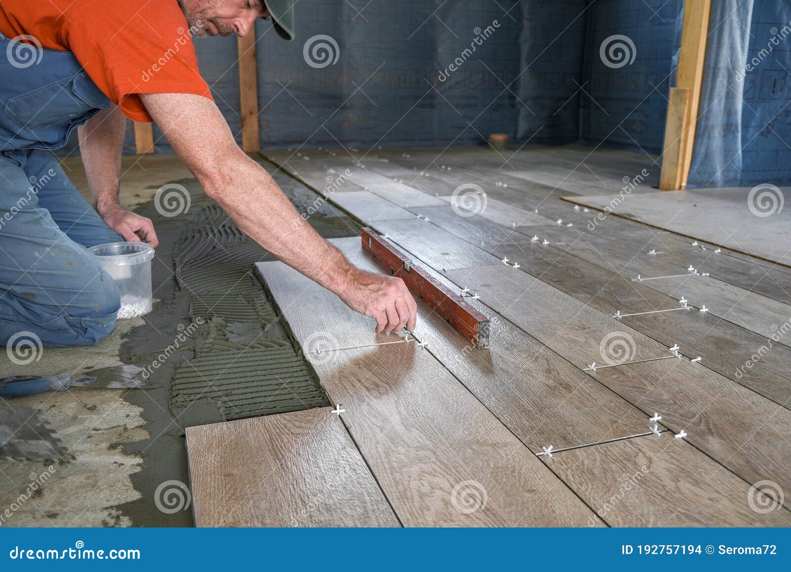 The Worker Puts Ceramic Tiles on the Construction Site Stock Photo ...