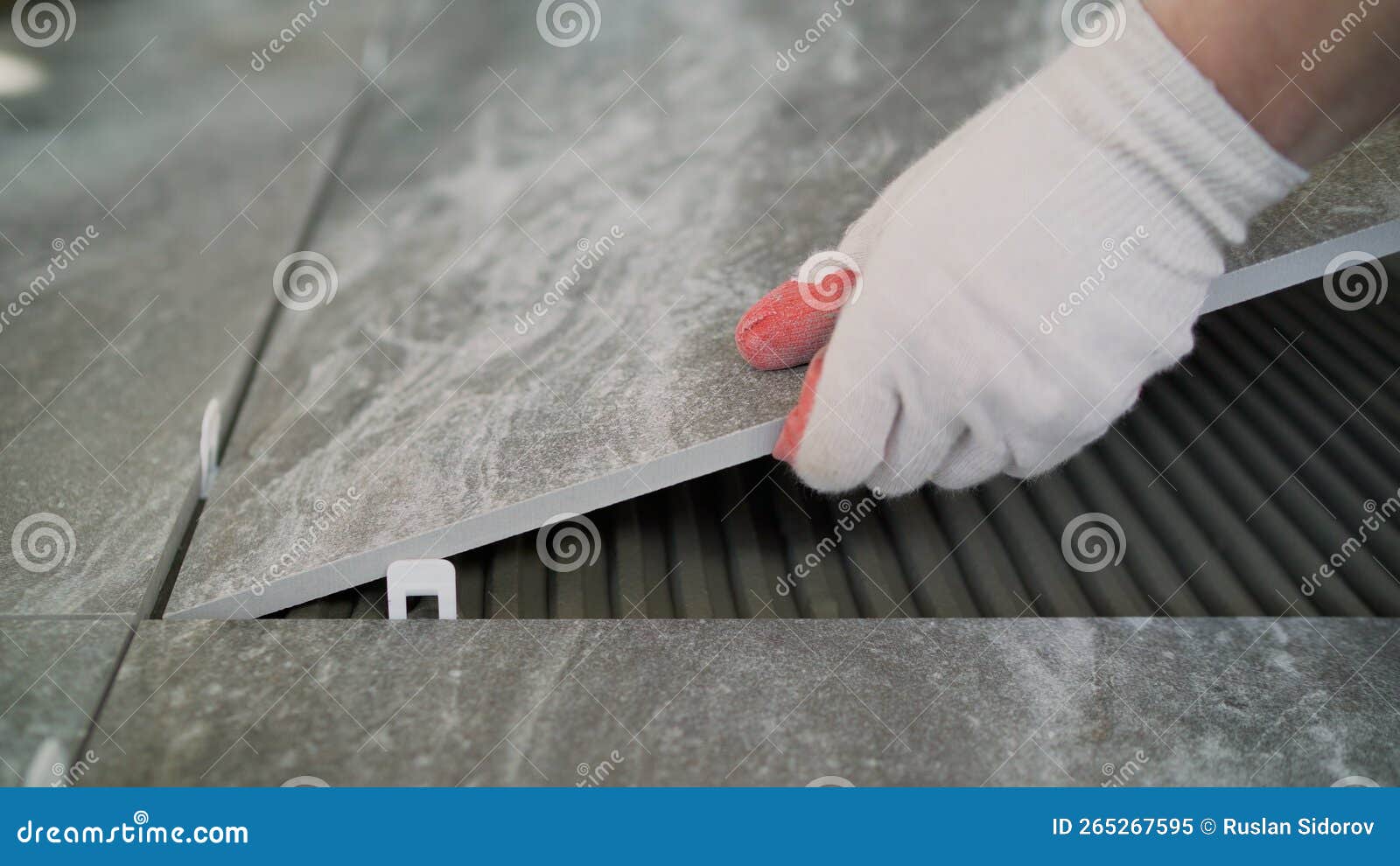 Workers are Laying the Floor with Large Tiles. a Worker Puts a Large ...
