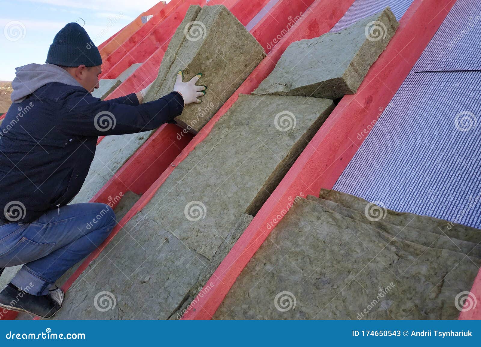 The Worker Puts Mineral Wool on the Roof, Insulating the House Stock ...