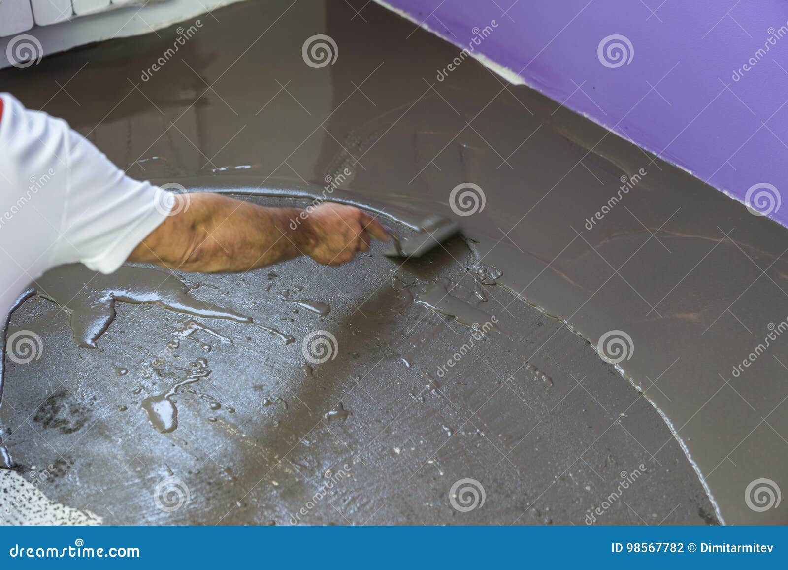 Worker Puts a Self Leveling Screed on Cement Floor Stock Photo - Image ...