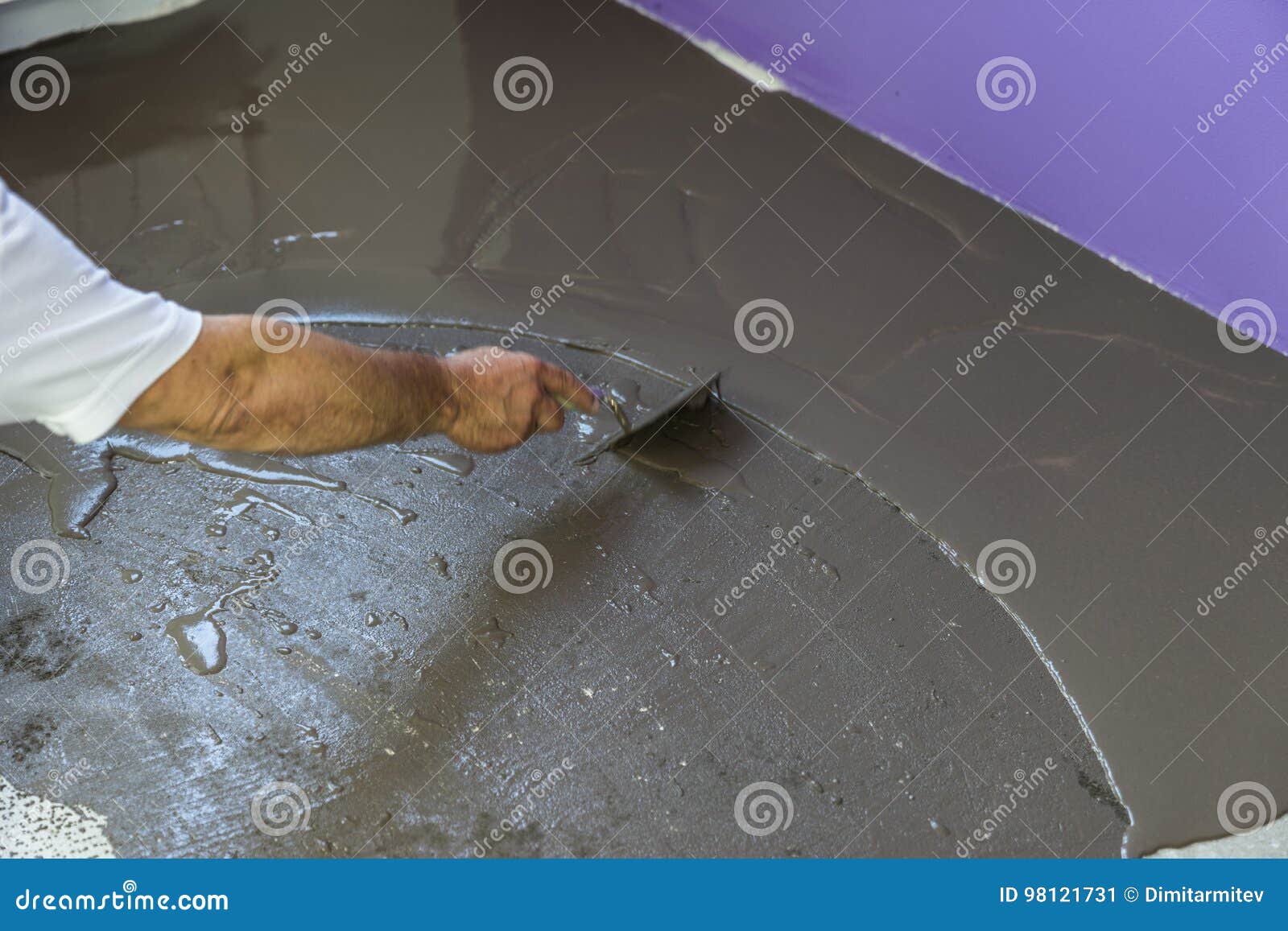 Worker Puts a Self Leveling Screed with Tool on Concrete Floor. Stock ...