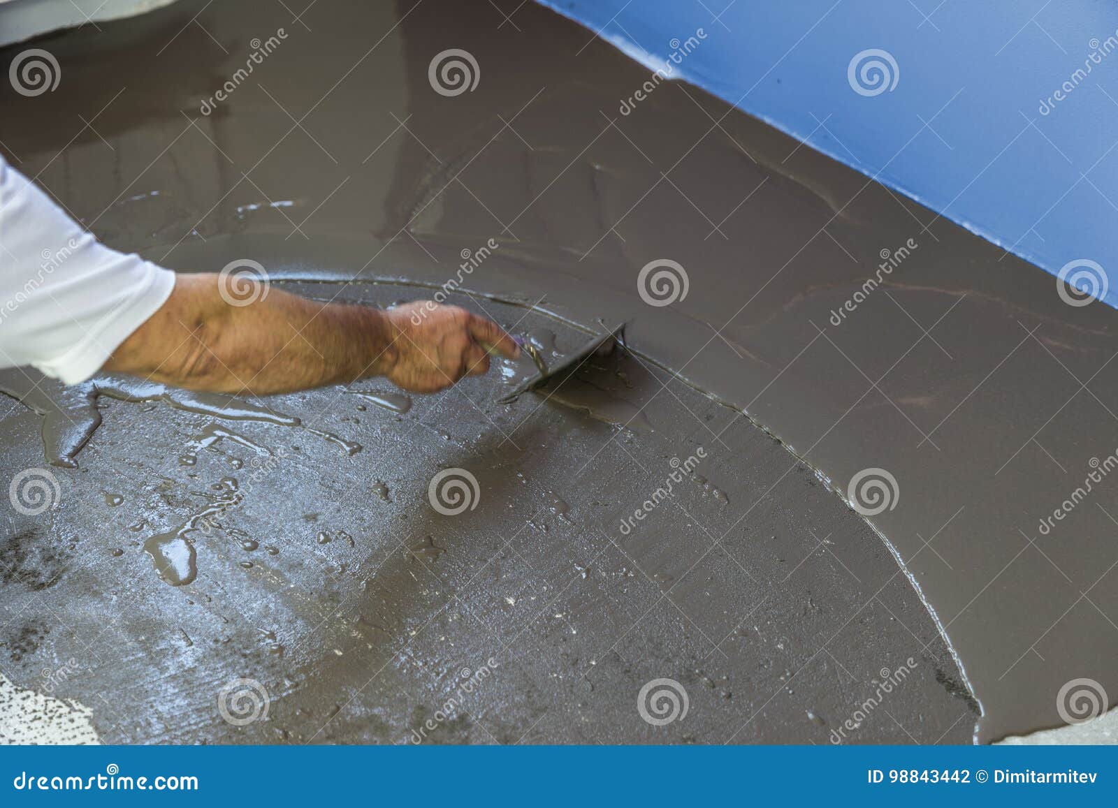 Worker Puts a Self Leveling Screed with Tool on Concrete Floor. Stock ...
