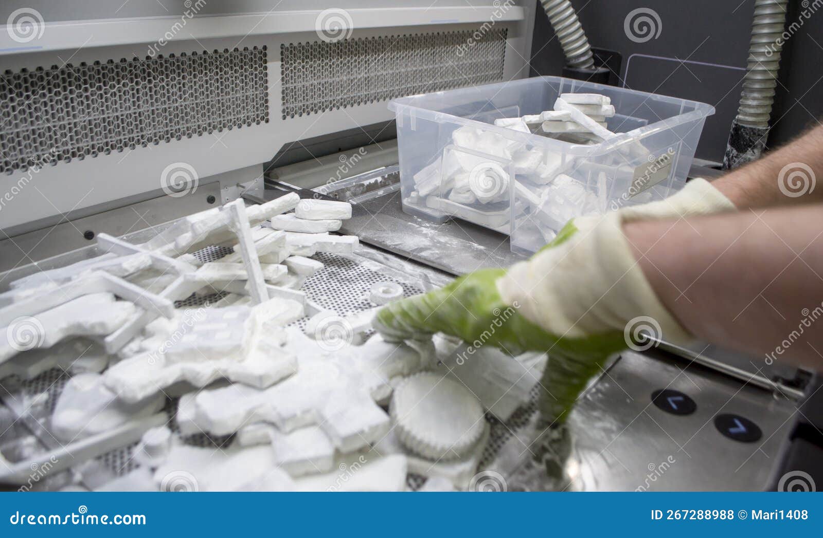 Worker Putting into Box Models Printed on 3D Printer and Covered White ...