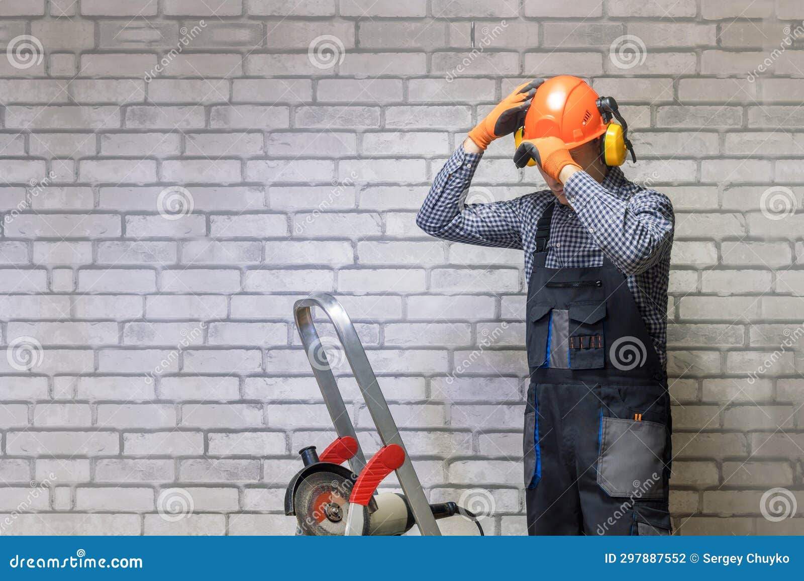 Worker Putting His Helmet on Head while Standing Inside Building in ...