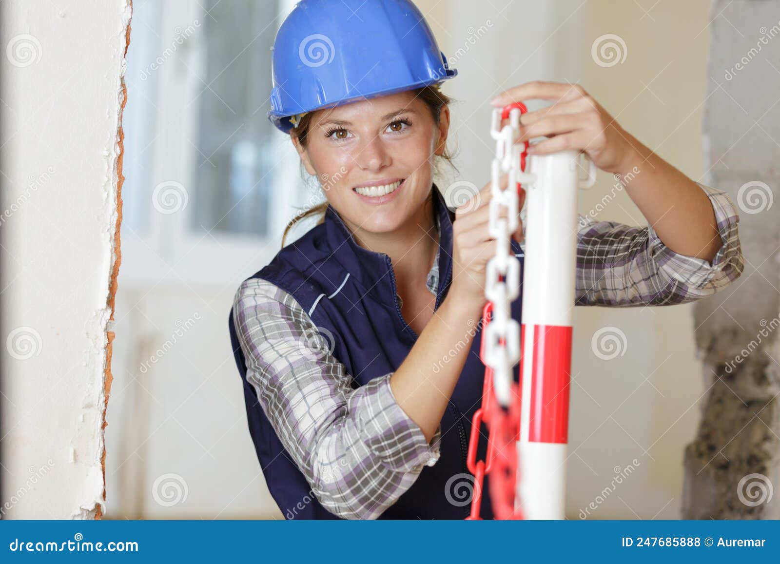 Worker Putting Up Exclusion Chain on Construction Site Stock Photo ...
