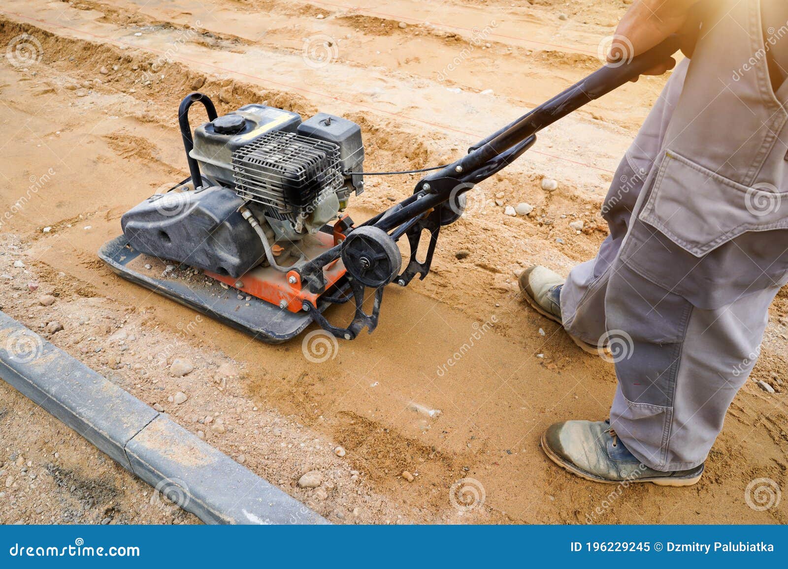 Worker Rams the Ground with a Vibrating Machine Stock Image - Image of ...
